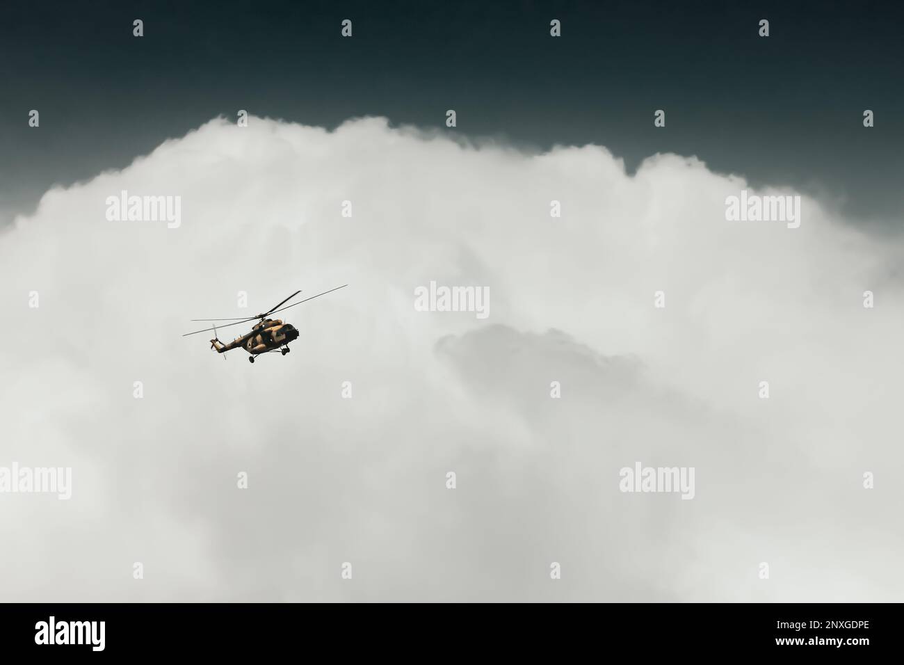 Coalition helicopter ofly over the sky with huge cloud in the ...