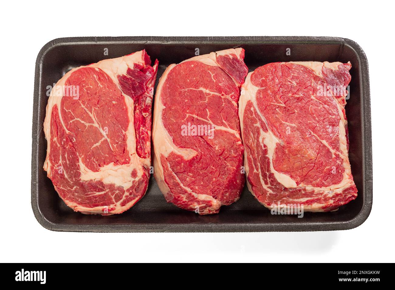Raw Rib Eye Steak in packaging on white background Stock Photo - Alamy