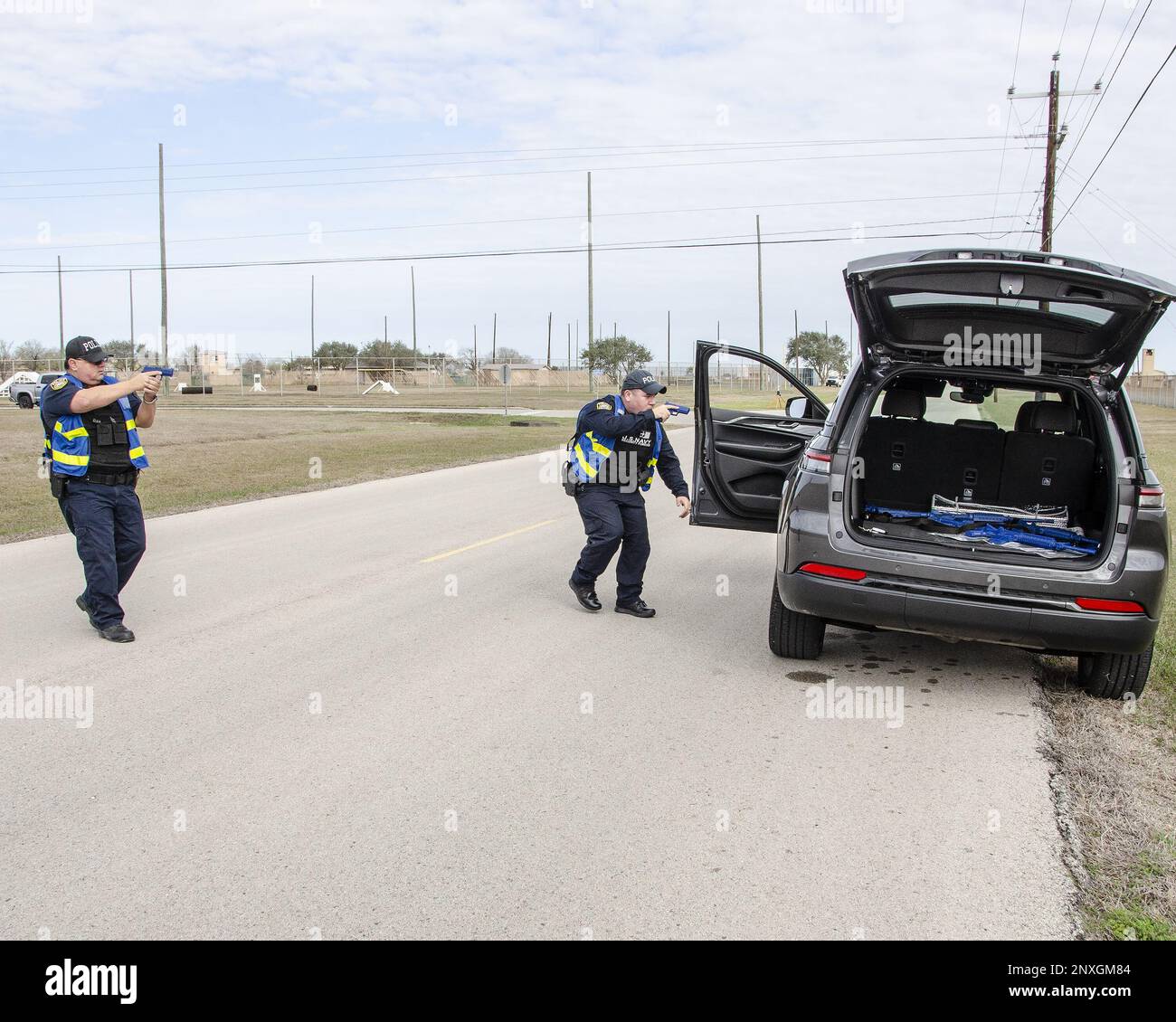 Naval Air Station Kingsville security officers check the vehicle of a ...