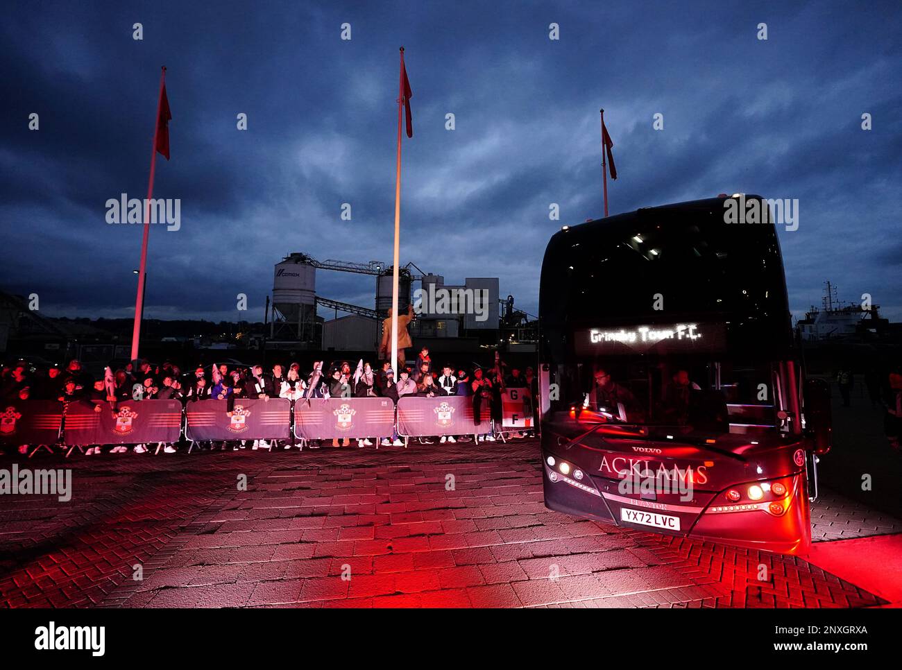 Fans wait as the Grimsby Town team bus arrives at the ground ahead of ...