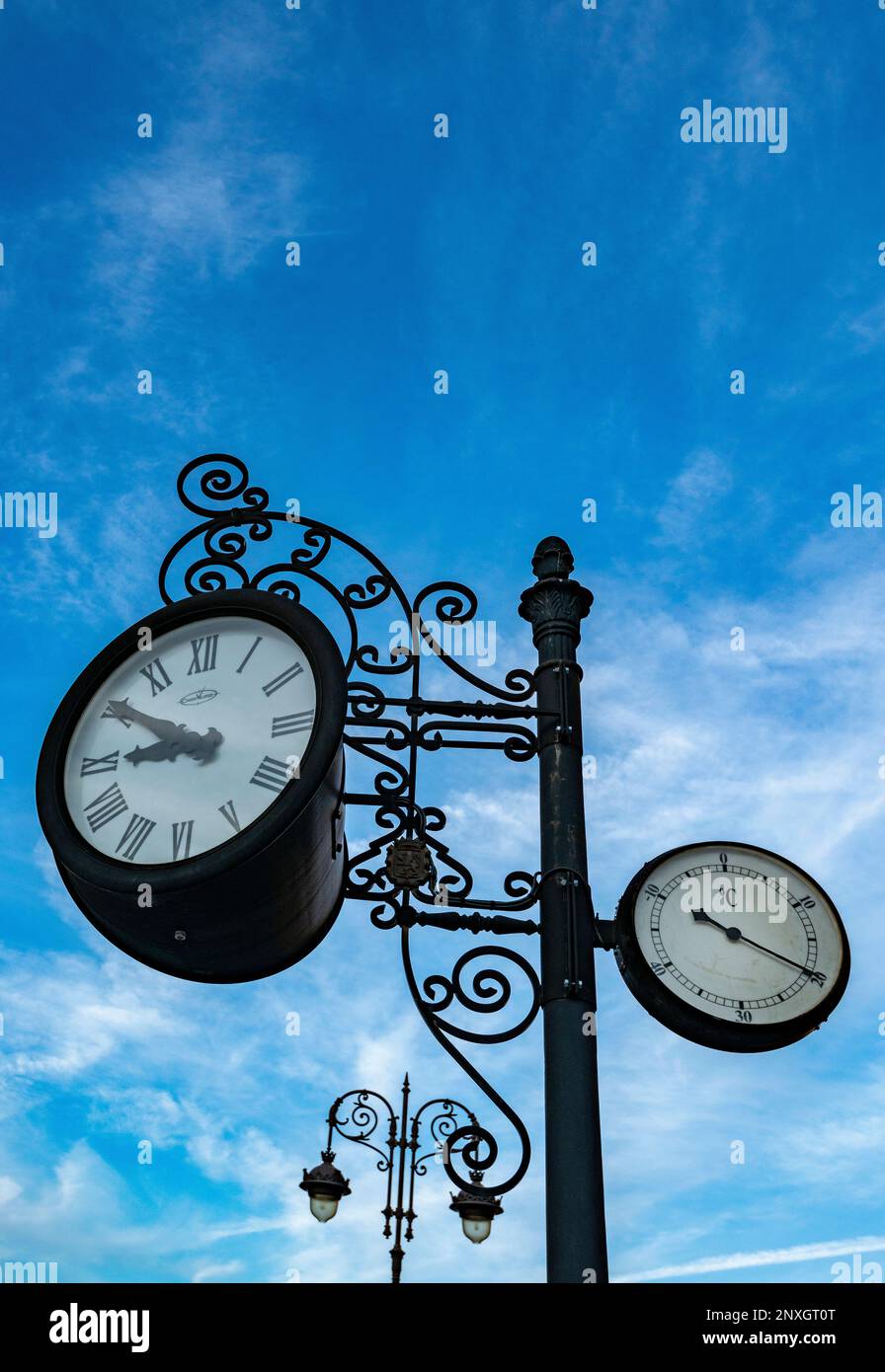 A clock tower with two faces, one displaying the time and the other ...