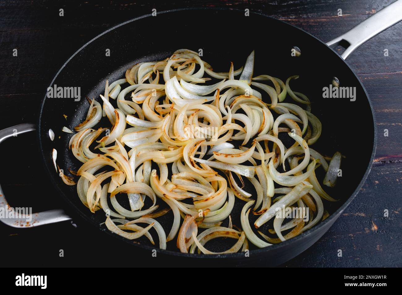 Sliced Onions Browning in a Large Saute Pan: Sweet onion slices ...