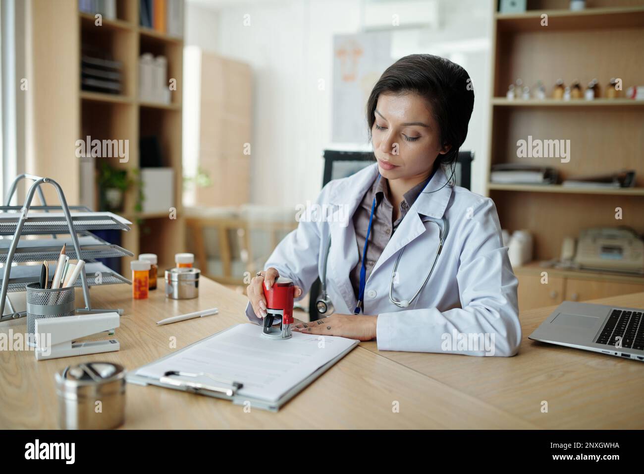 Serious hdical office sealing documets Stock Photo - Alamy
