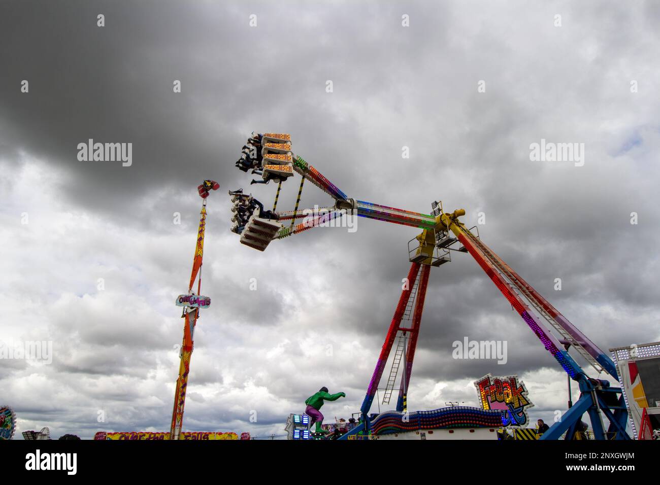 EXETER, DEVON, UK - JULY 1, 2022 fun fair rides with storm clouds Stock ...