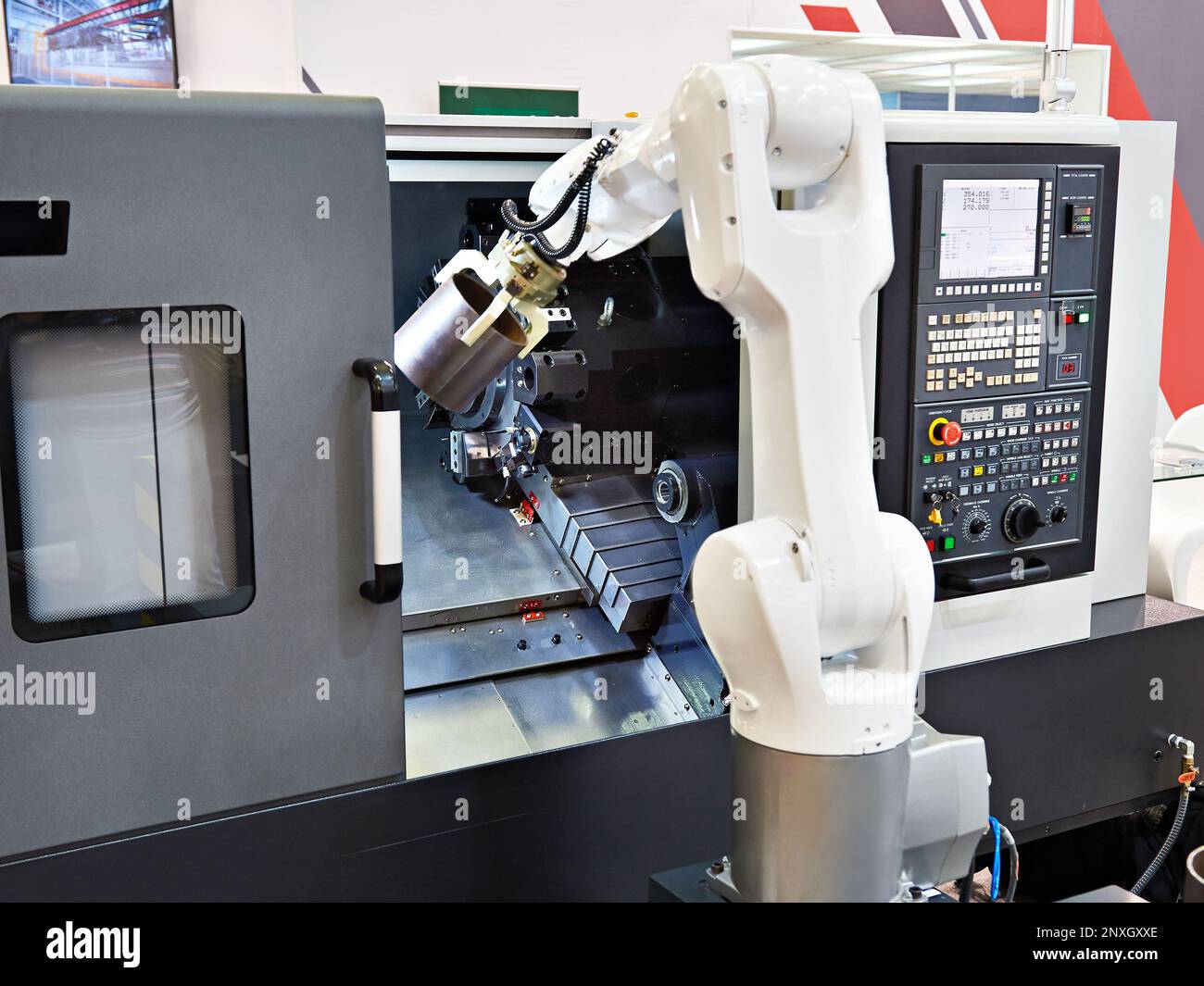 Standard universal industrial robot with part and cnc lathe machine Stock Photo - Alamy