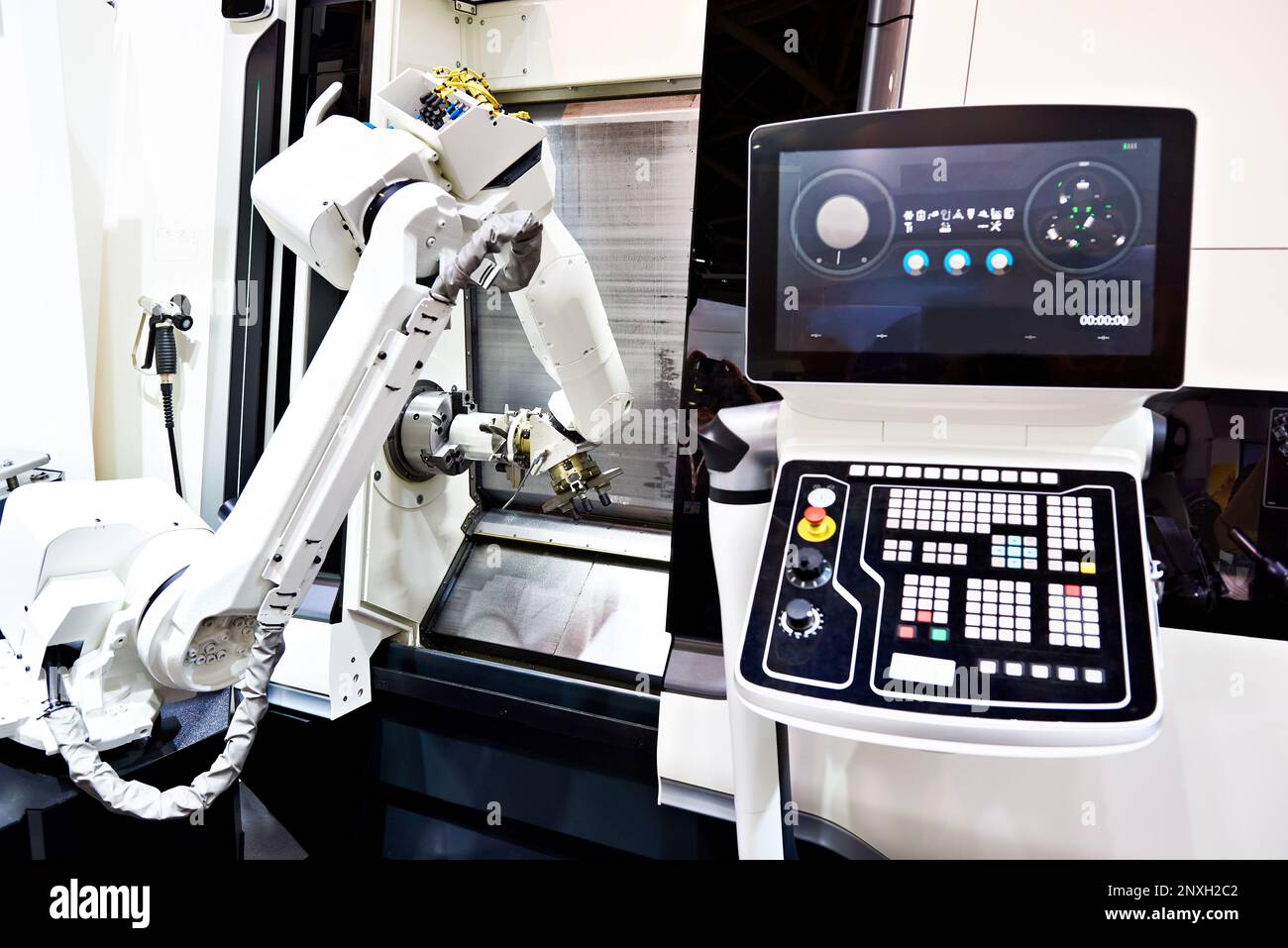Robotic arm and cnc lathe machine Stock Photo - Alamy