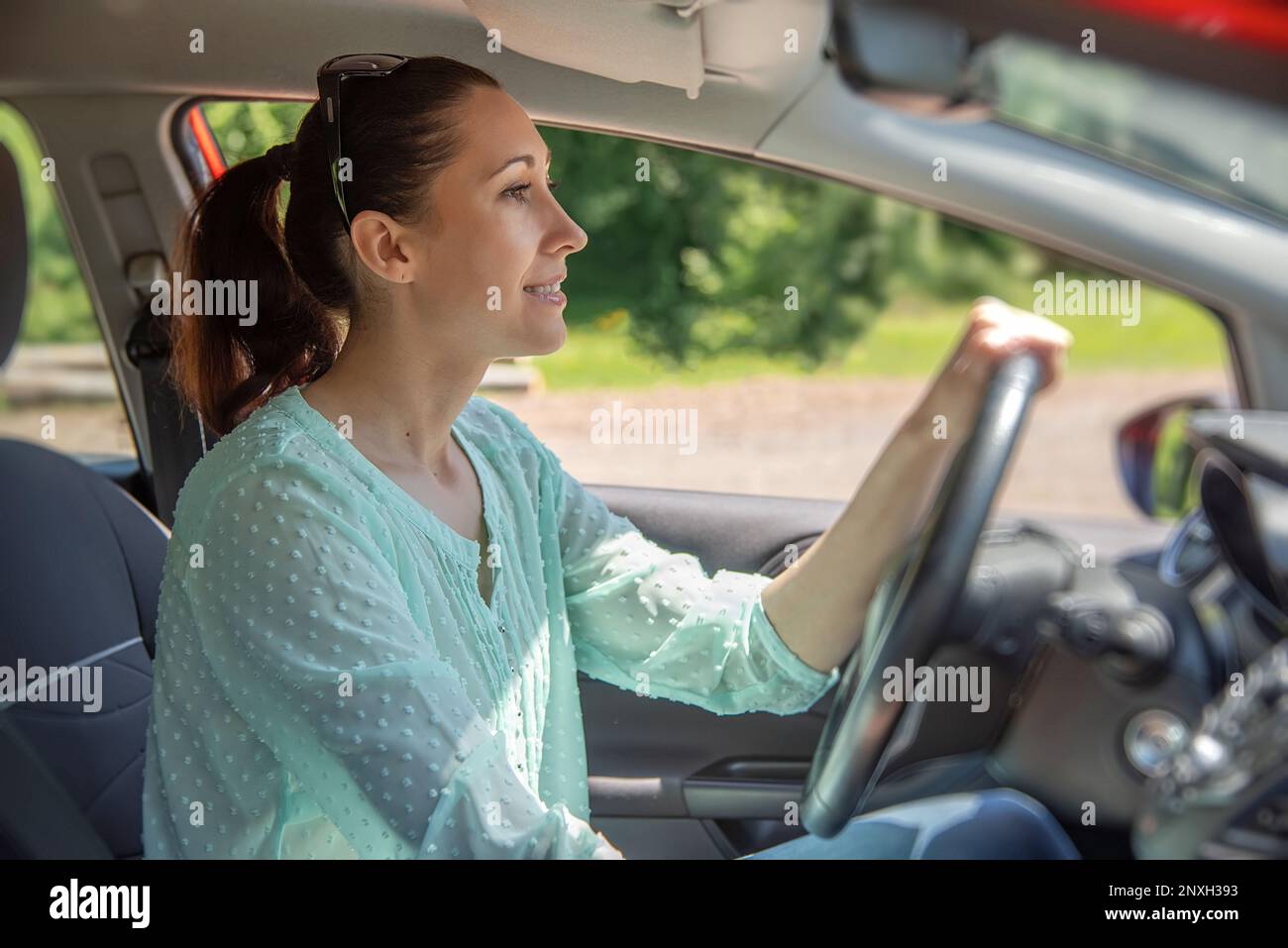 Woman drives a car on the road Stock Photo - Alamy
