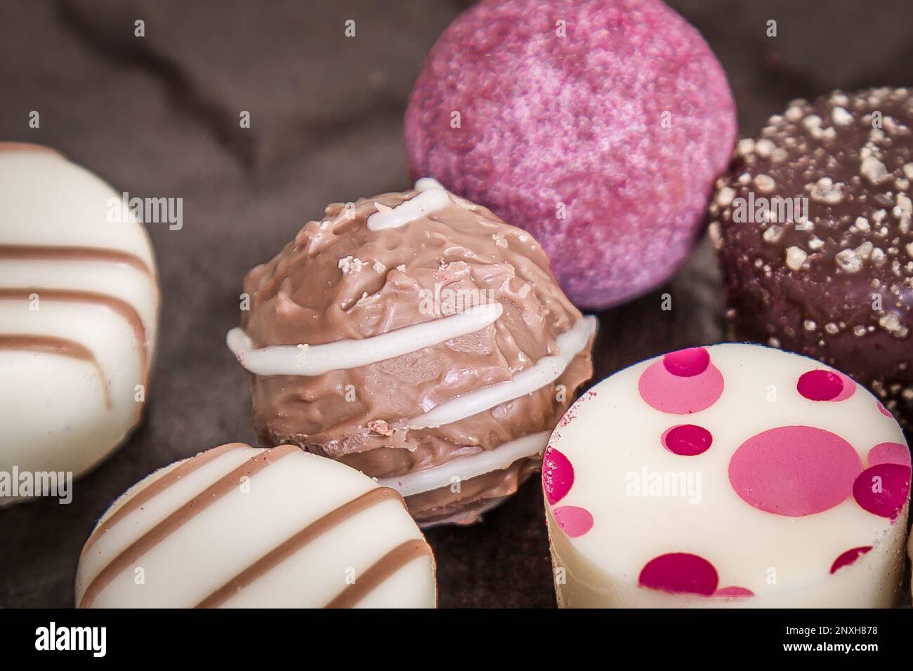 Chocolate pralines truffles on dark background. Pattern for postcard ...