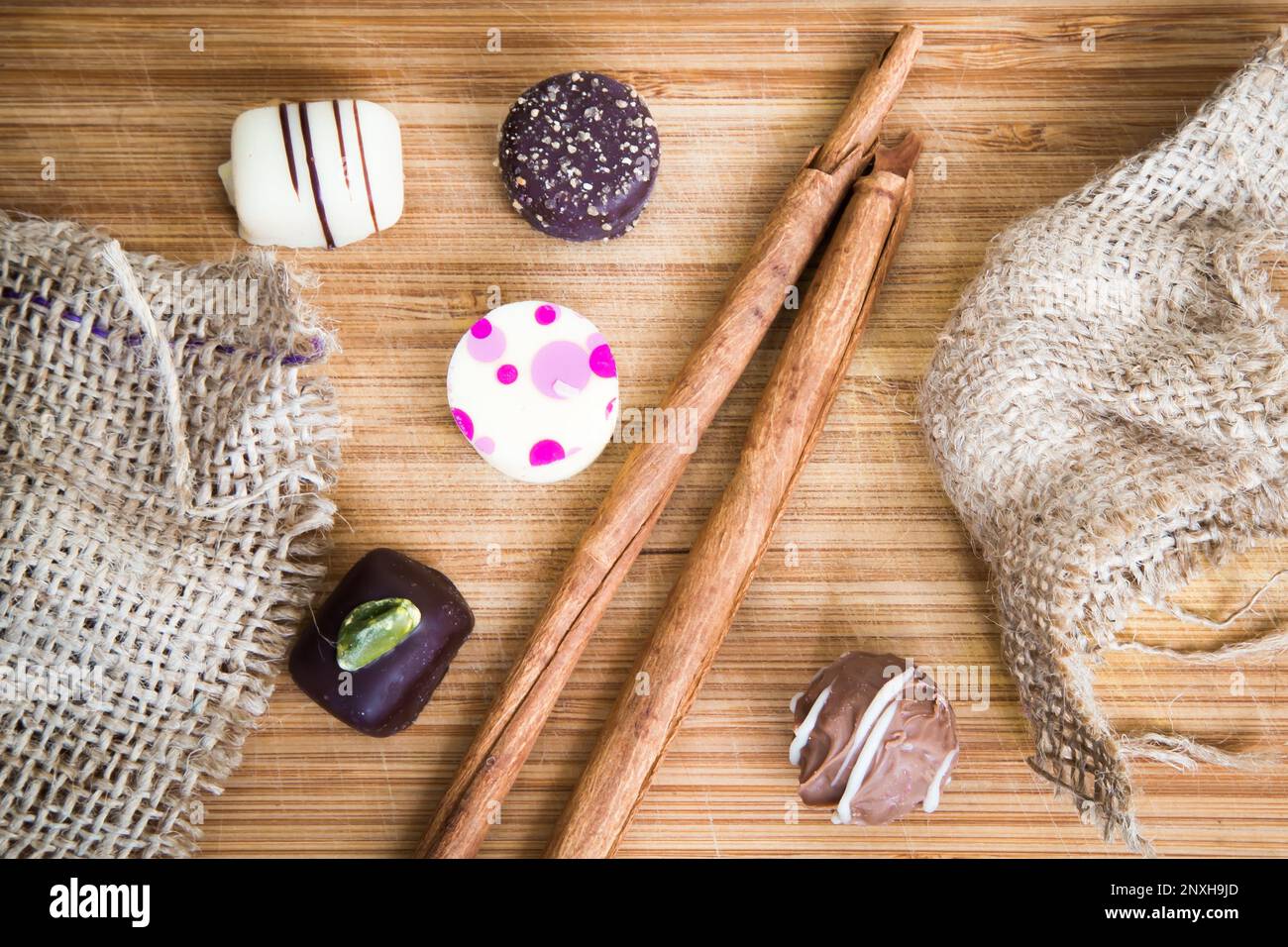 Chocolate candies and pralines with pink dots and decorated with ...
