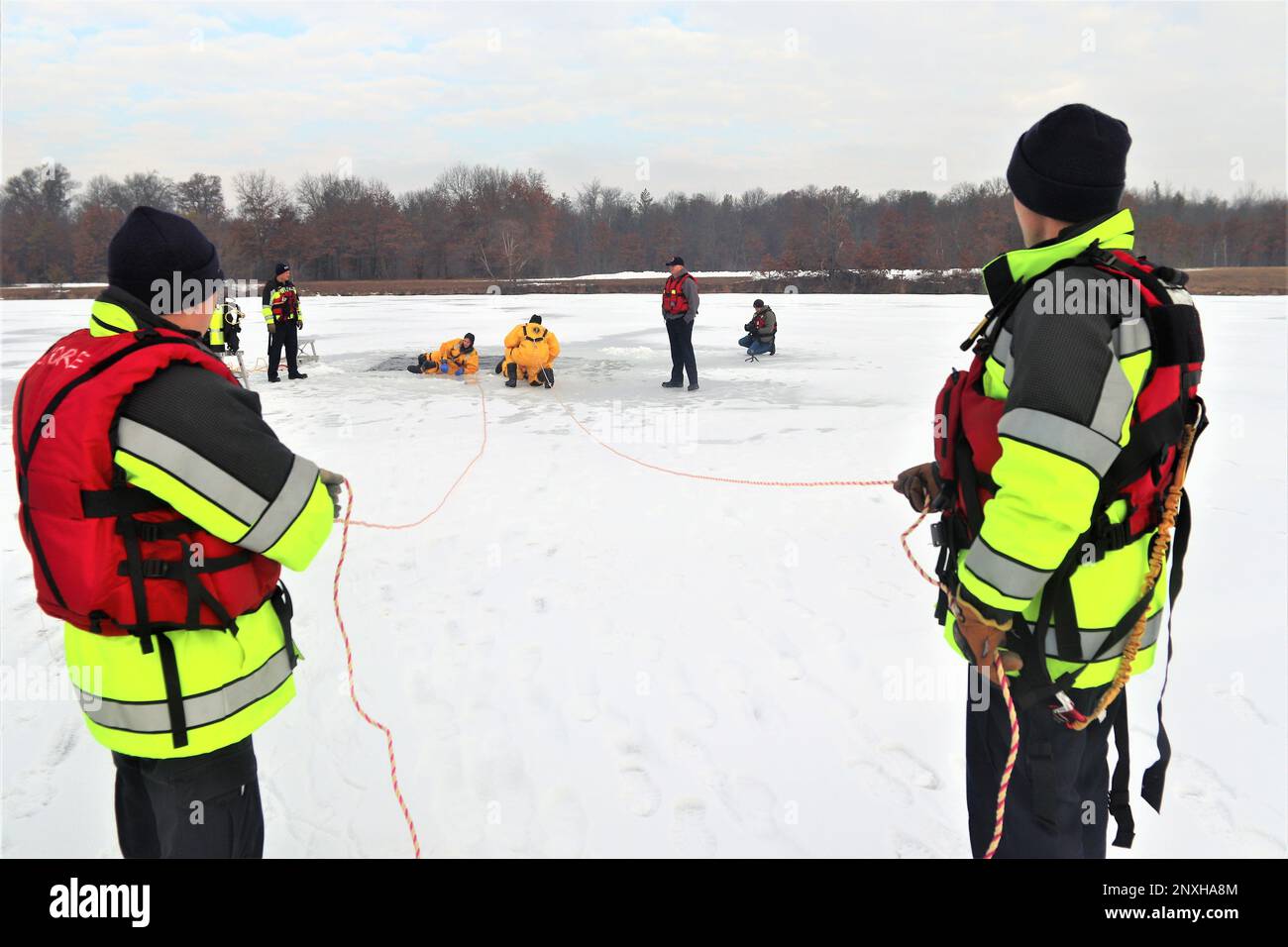 Firefighters wearing cold-water immersion protective suits hold surface ...