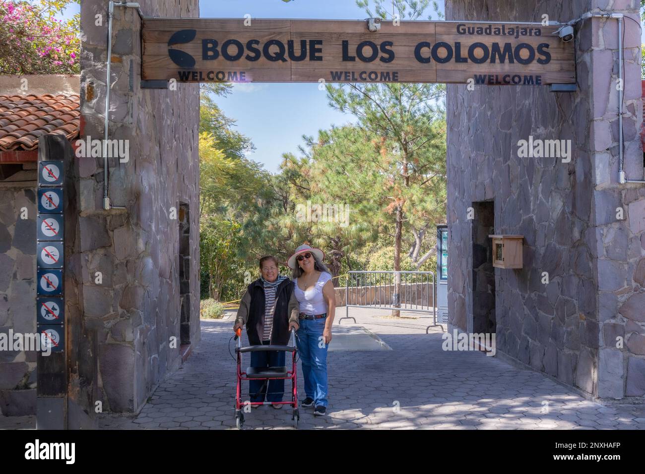 Adult daughter standing next to her mother giving her help and support ...