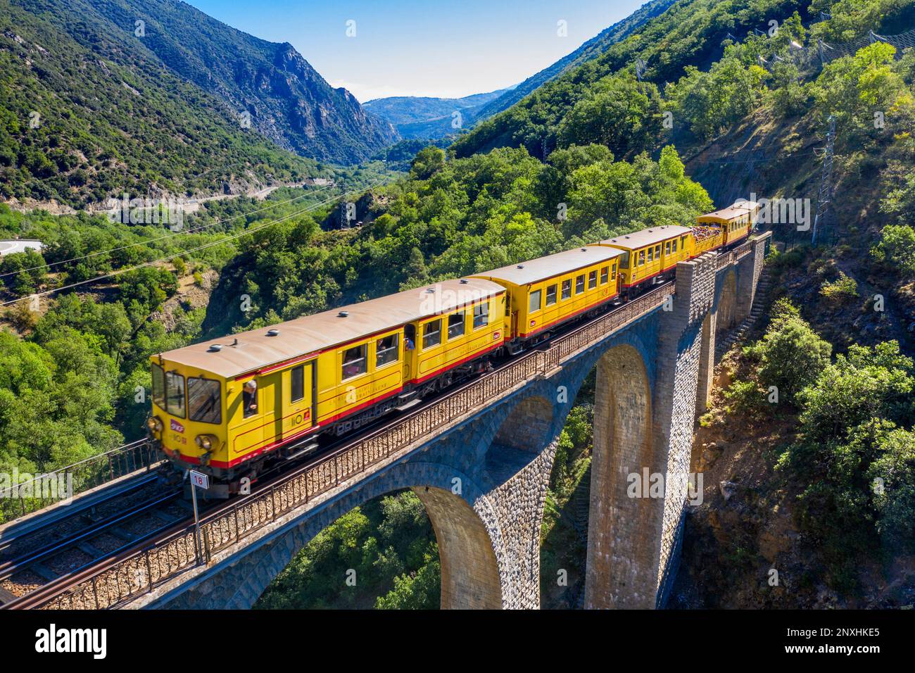 Aerial view of The Yellow Train or Train Jaune on Sejourne bridge ...