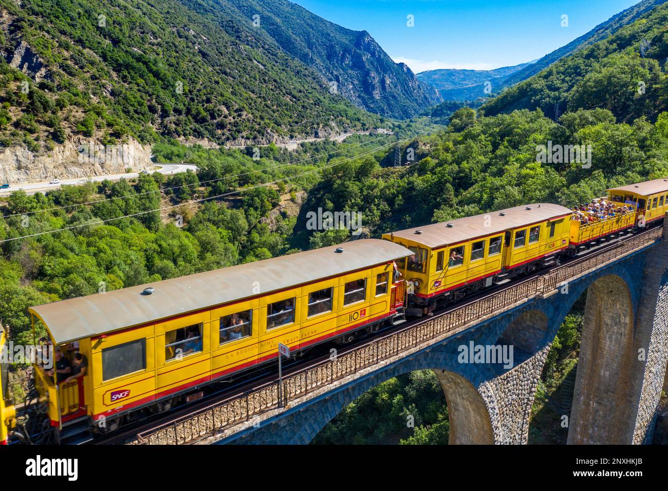 Aerial view of The Yellow Train or Train Jaune on Sejourne bridge ...