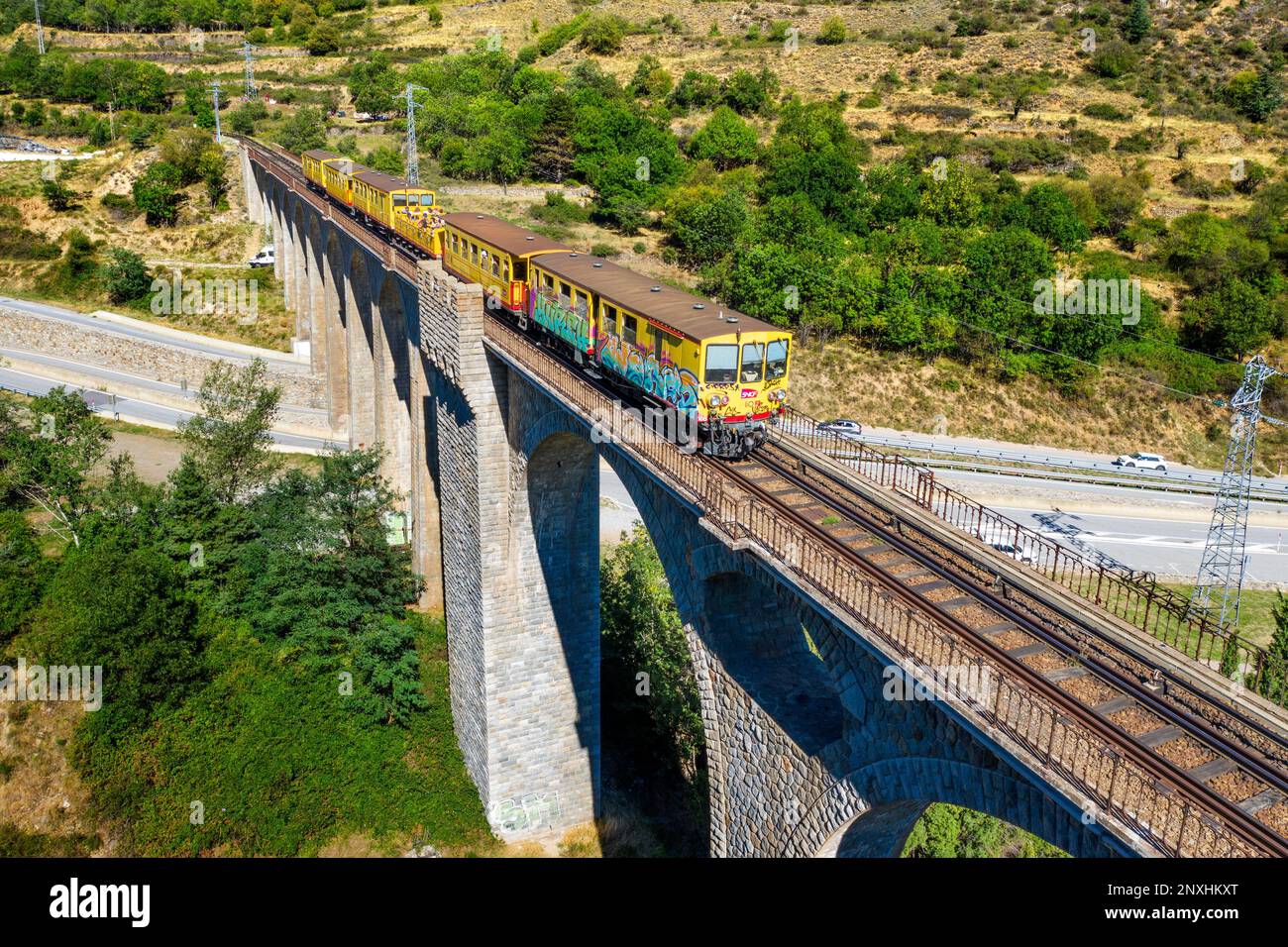 Aerial view of The Yellow Train or Train Jaune on Sejourne bridge ...
