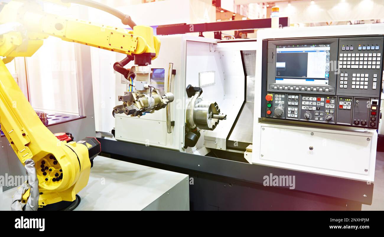 Robotic arm and cnc lathe machine Stock Photo - Alamy