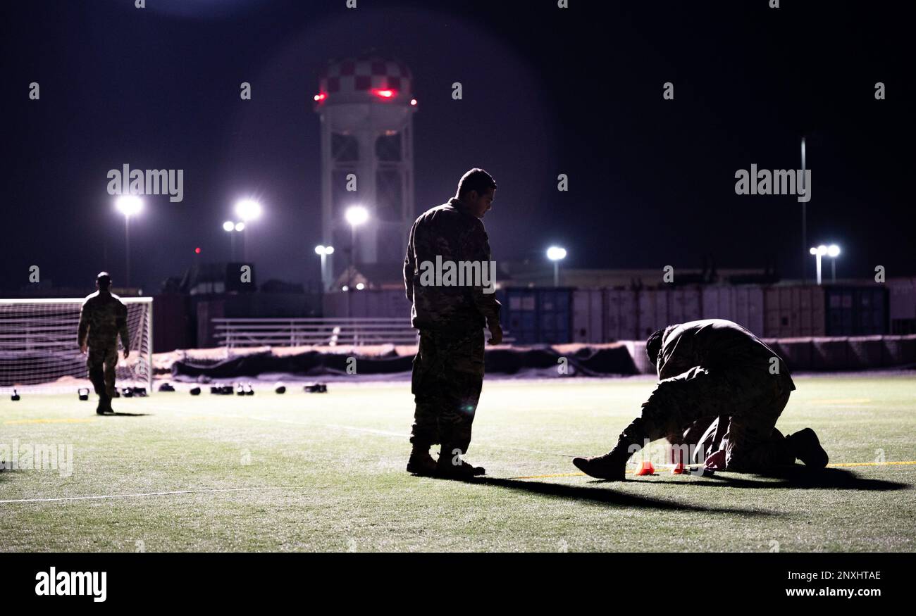 U.S. Army soldiers set up cones in preparation for the Army Combat ...