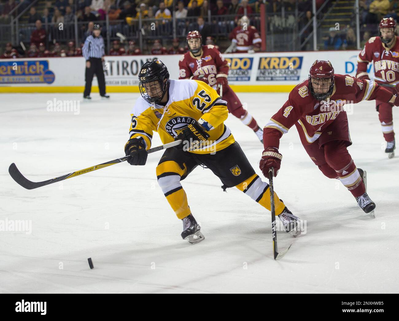 Colorado College forward Brian Williams (25) and Denver defenseman ...