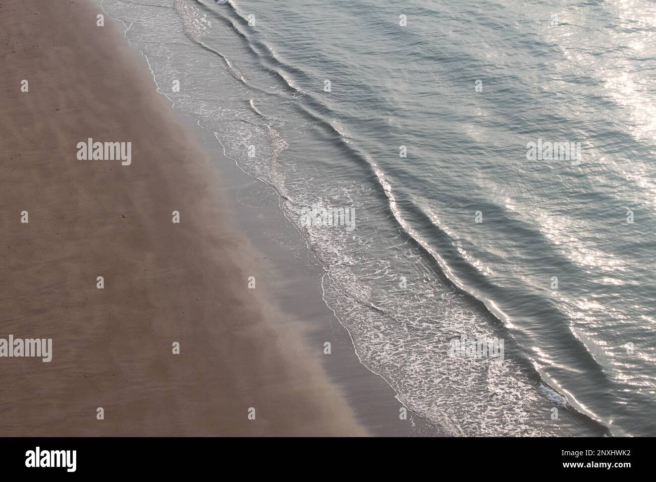 smooth waves on a colourful beach at the Persian Gulf with colours in ...