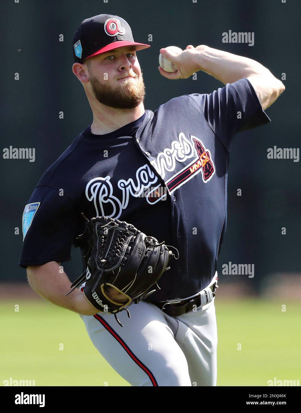 Atlanta Braves pitcher A.J. Minter loosens up during baseball spring ...