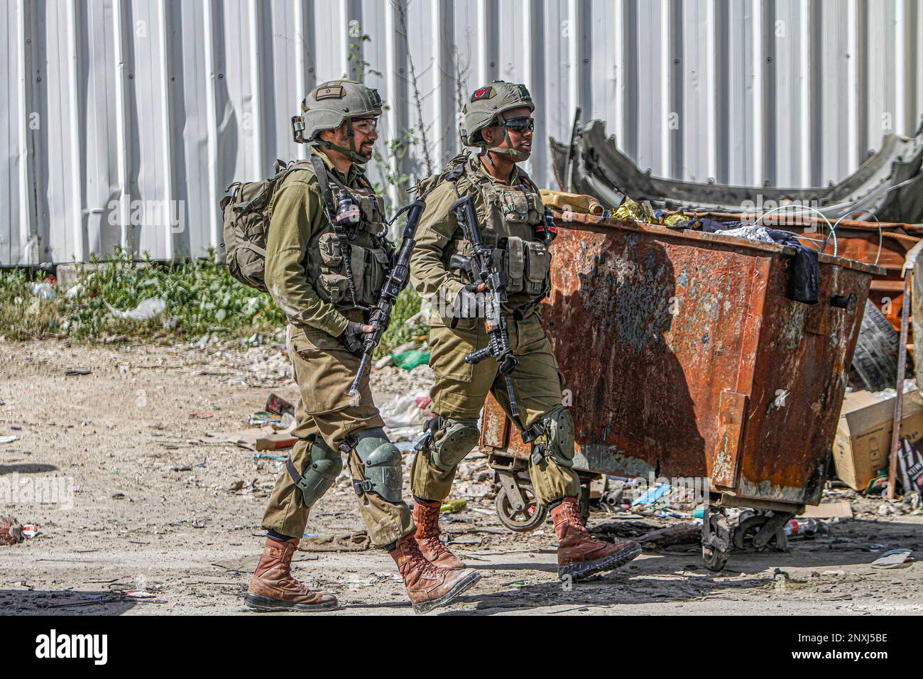 Israeli soldiers patrol the streets in the town of Hawara, south of ...