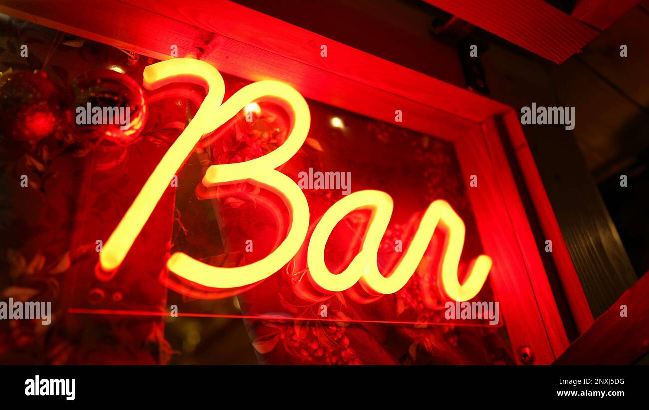 Bar fluorescent sign Light glowing at night in entrance door. Red Bar ...