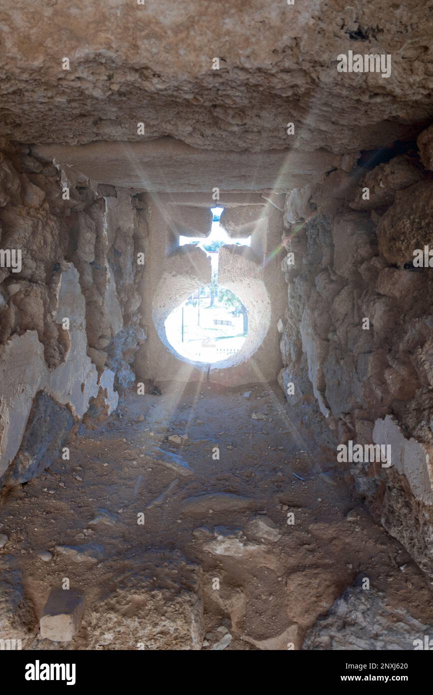 Rays of light passing through the small stone window of a medieval ...