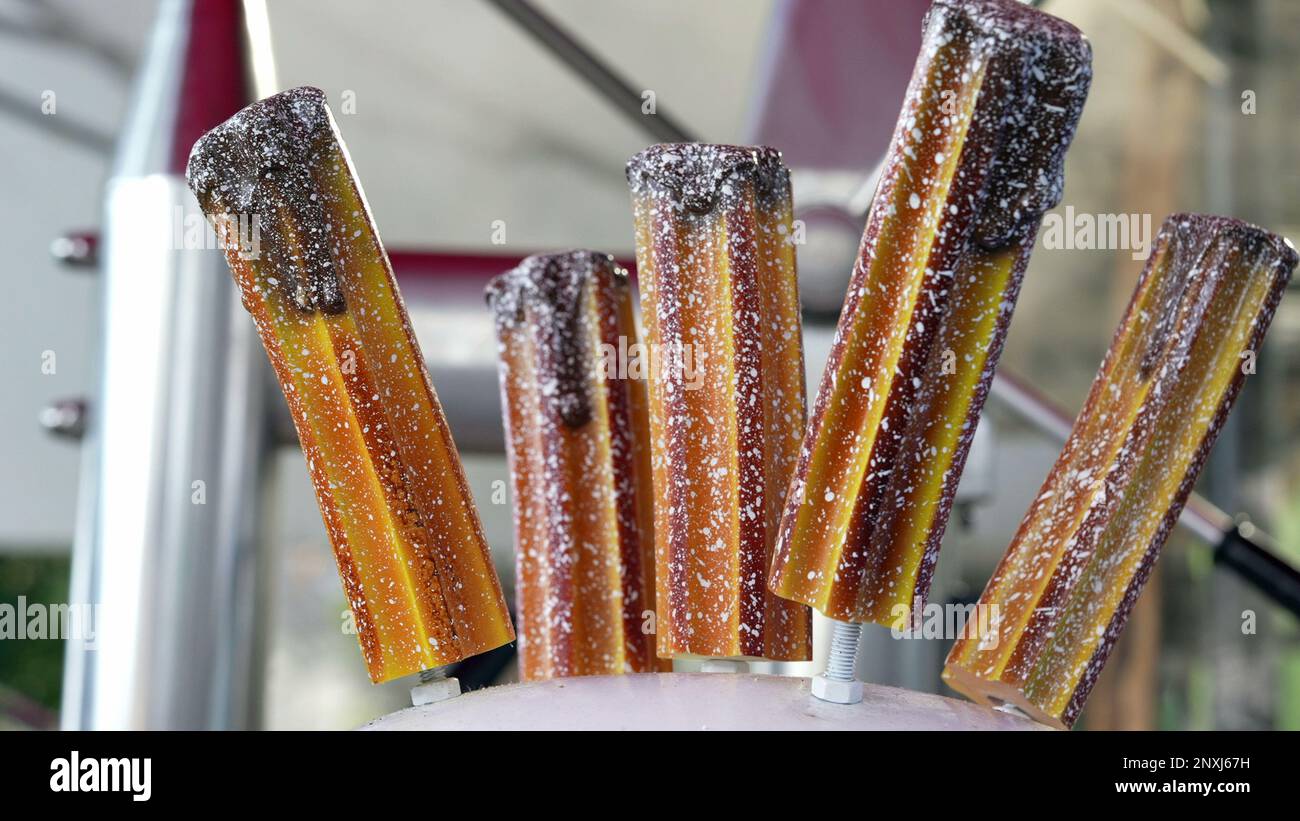 Churros on display for consumption. Sweet sugar dessert carb at ...