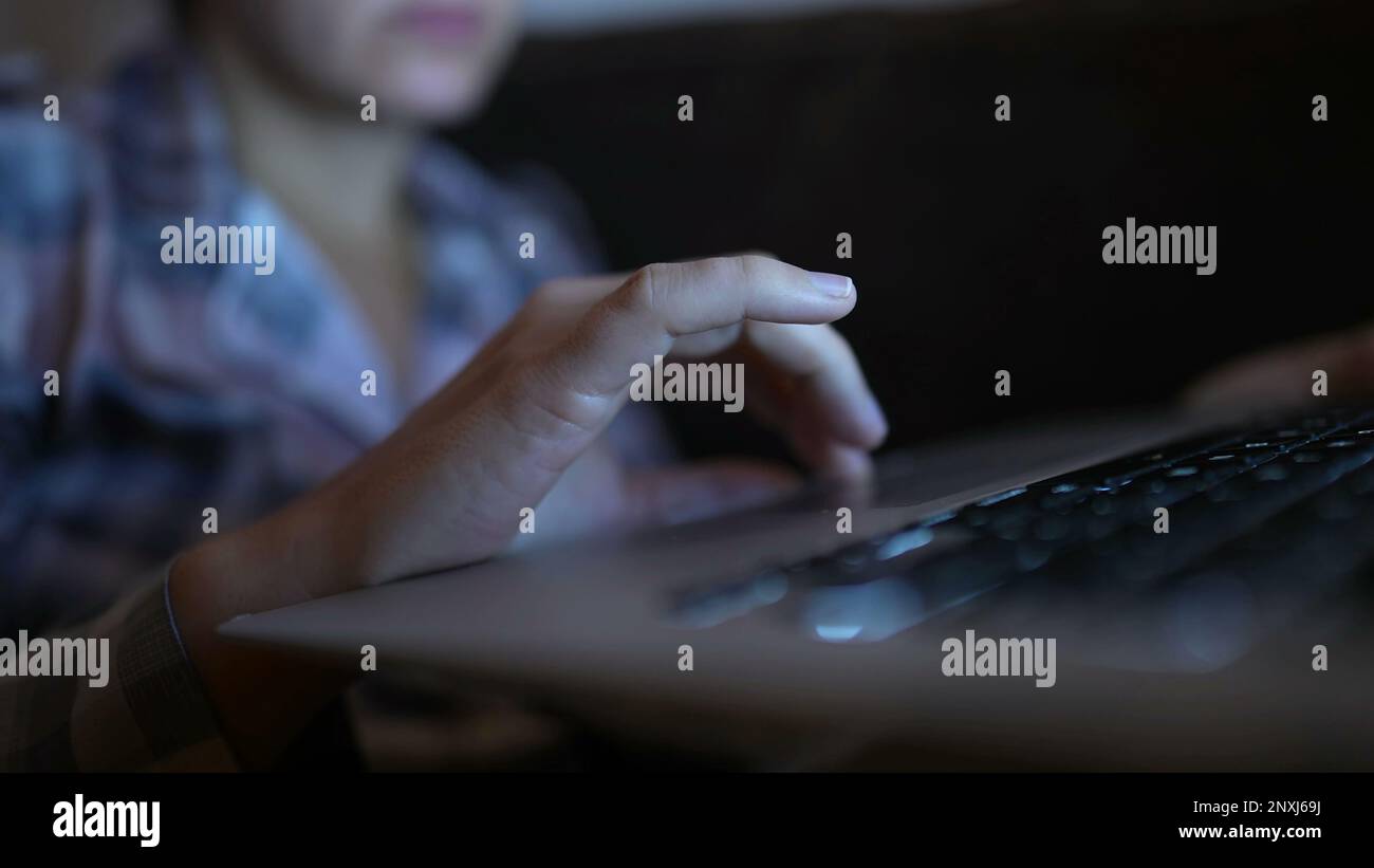 Closeup woman brosing internet on laptop at home using trackpad. Person ...