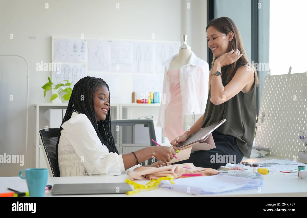 Fashion designers working together in their studio Stock Photo - Alamy