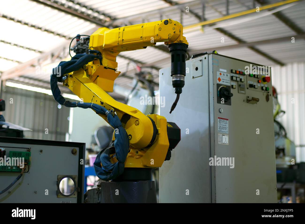 Robotic arm in futuristic assembly manufacturing factory, in factory ...