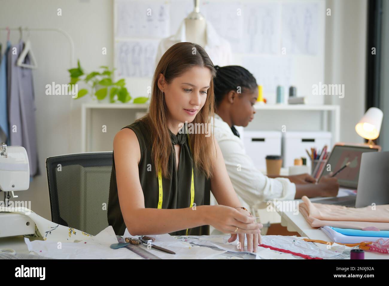 Fashion designers working together in their studio Stock Photo - Alamy