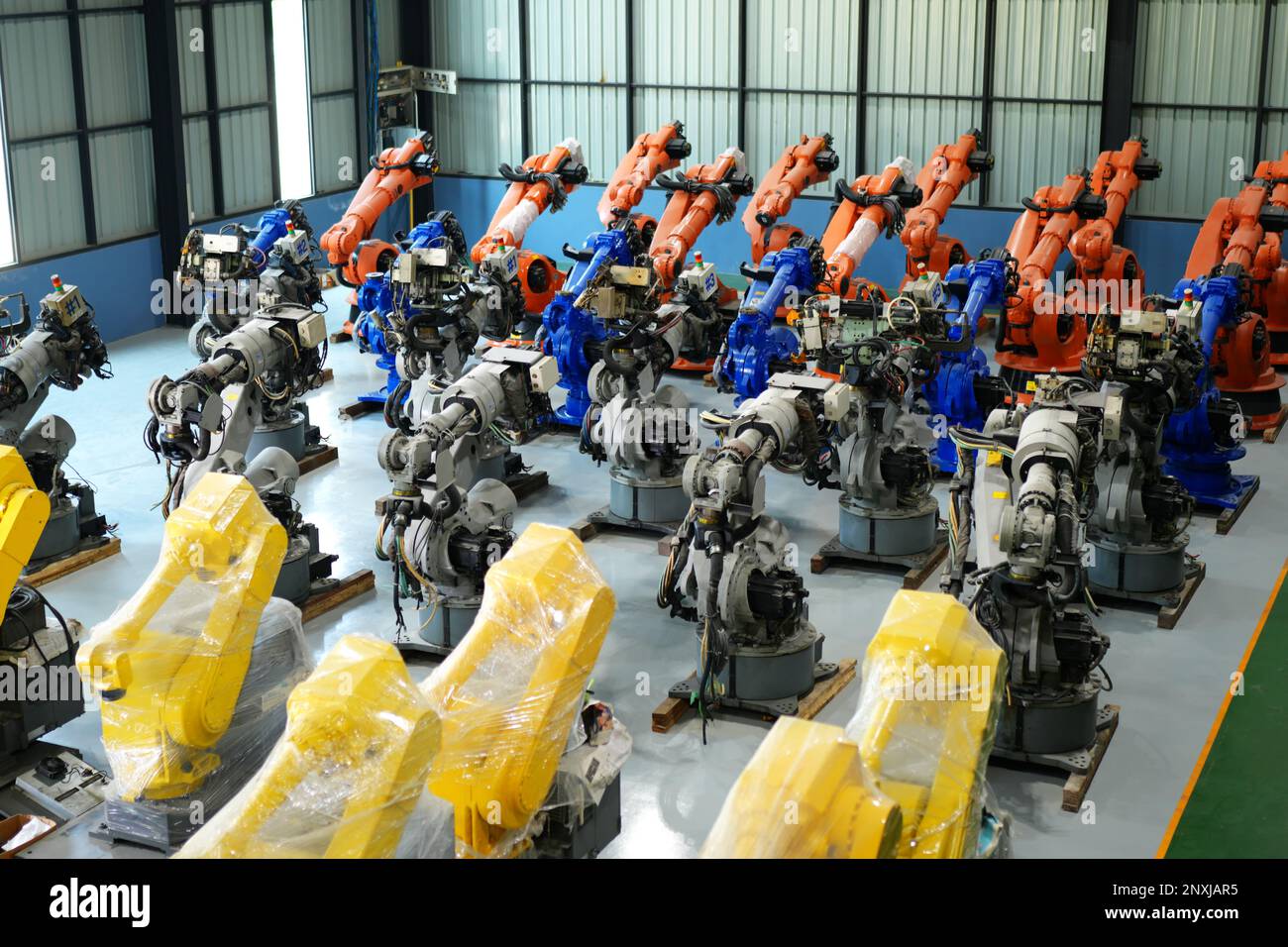 Robotic arm in futuristic assembly manufacturing factory, in factory ...