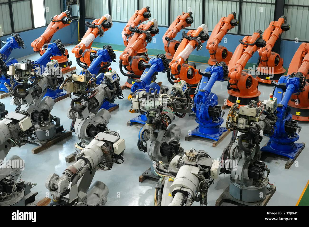 Robotic arm in futuristic assembly manufacturing factory, in factory ...