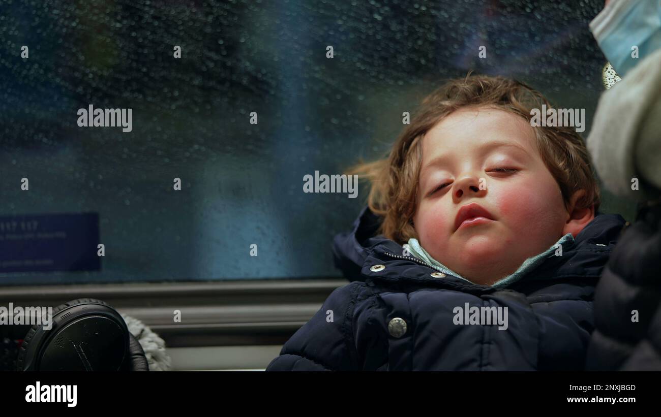 One cute little boy sleeping inside subway train. Child asleep on ...