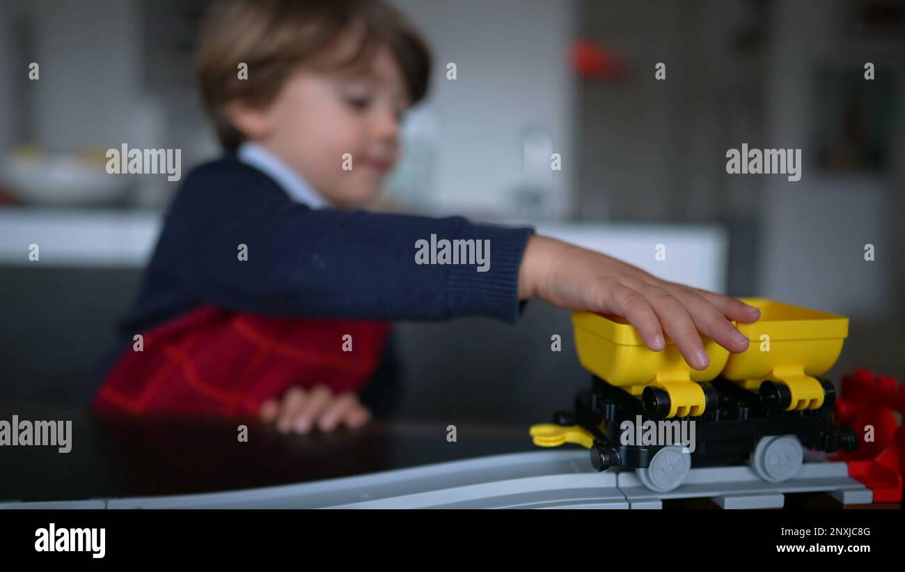 One little boy hands playing with train toy. Child hand pushing plastic ...
