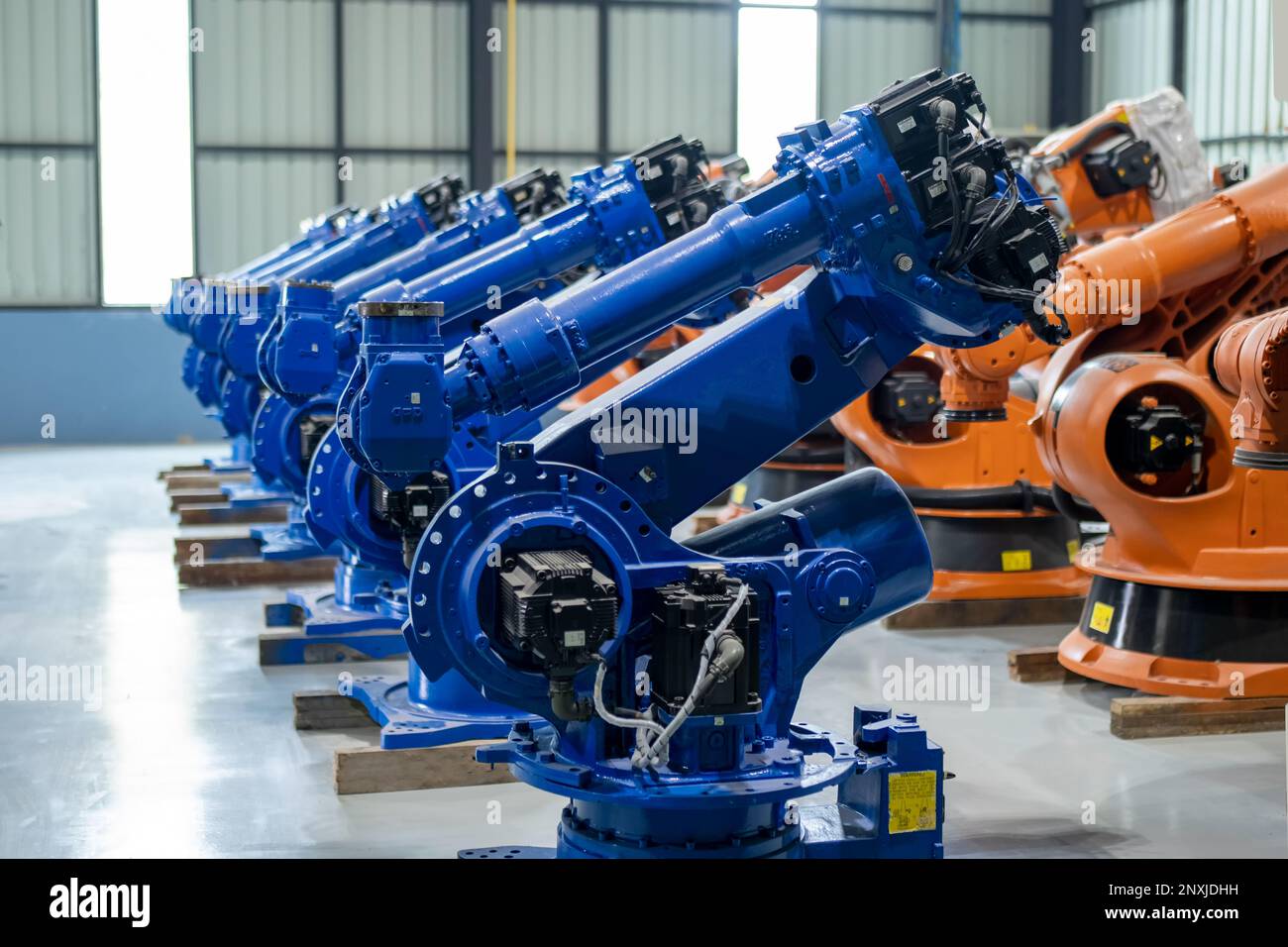 Robotic arm in futuristic assembly manufacturing factory, in factory ...
