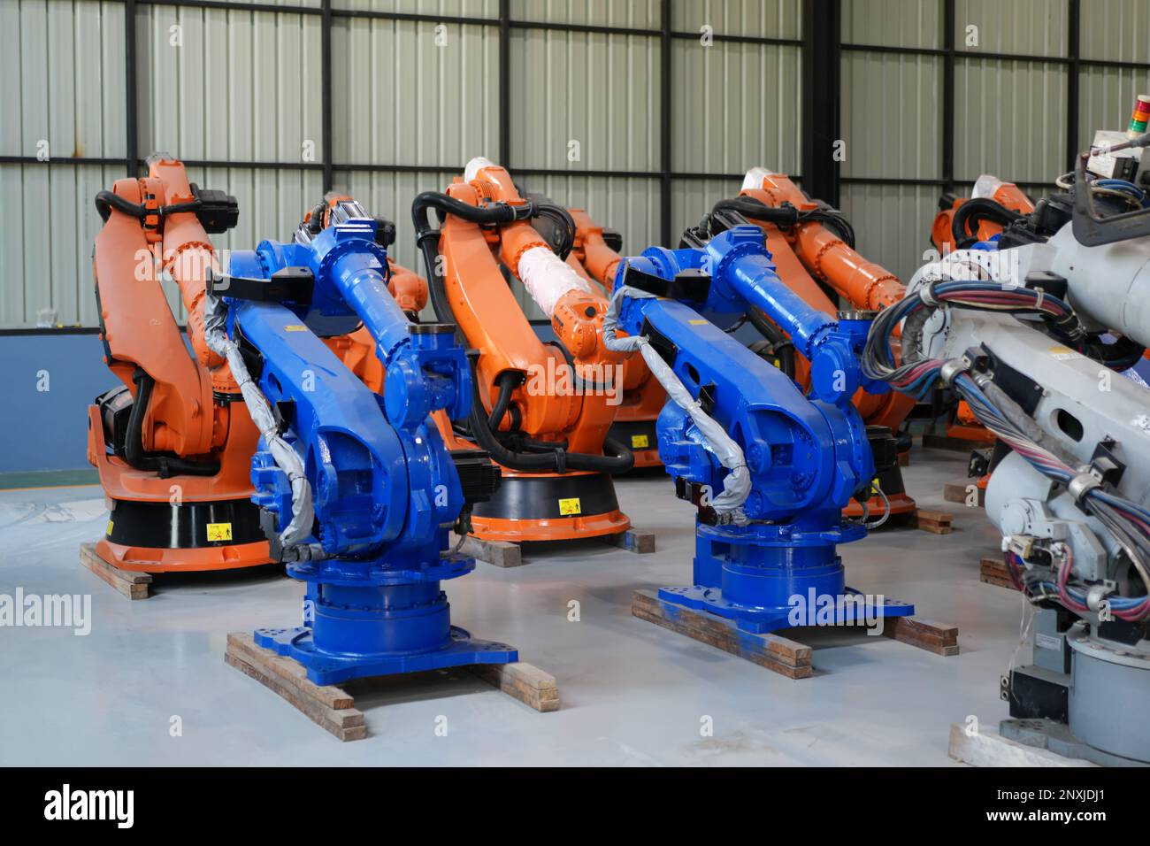 Robotic arm in futuristic assembly manufacturing factory, in factory ...