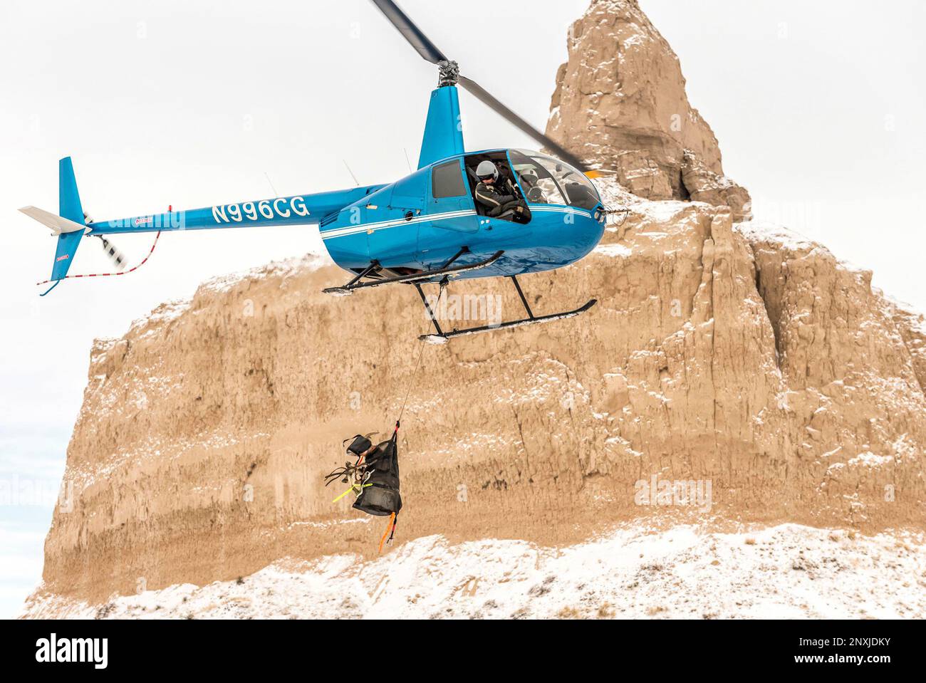 In this Saturday, Feb. 10, 2018 photo, a helicopter crew carries a ...