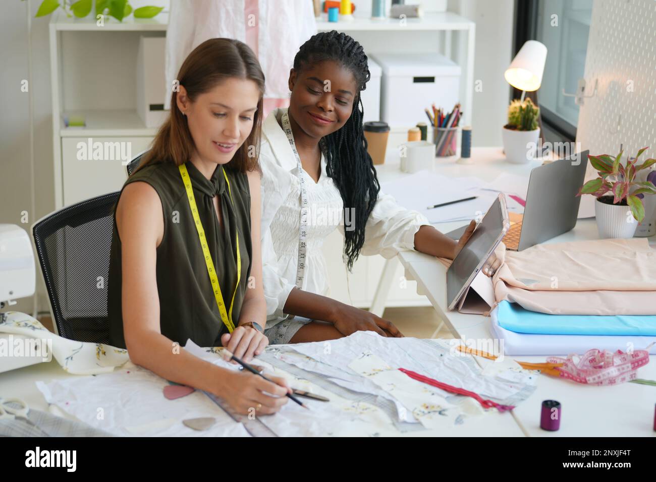 Fashion designers working together in their studio Stock Photo - Alamy