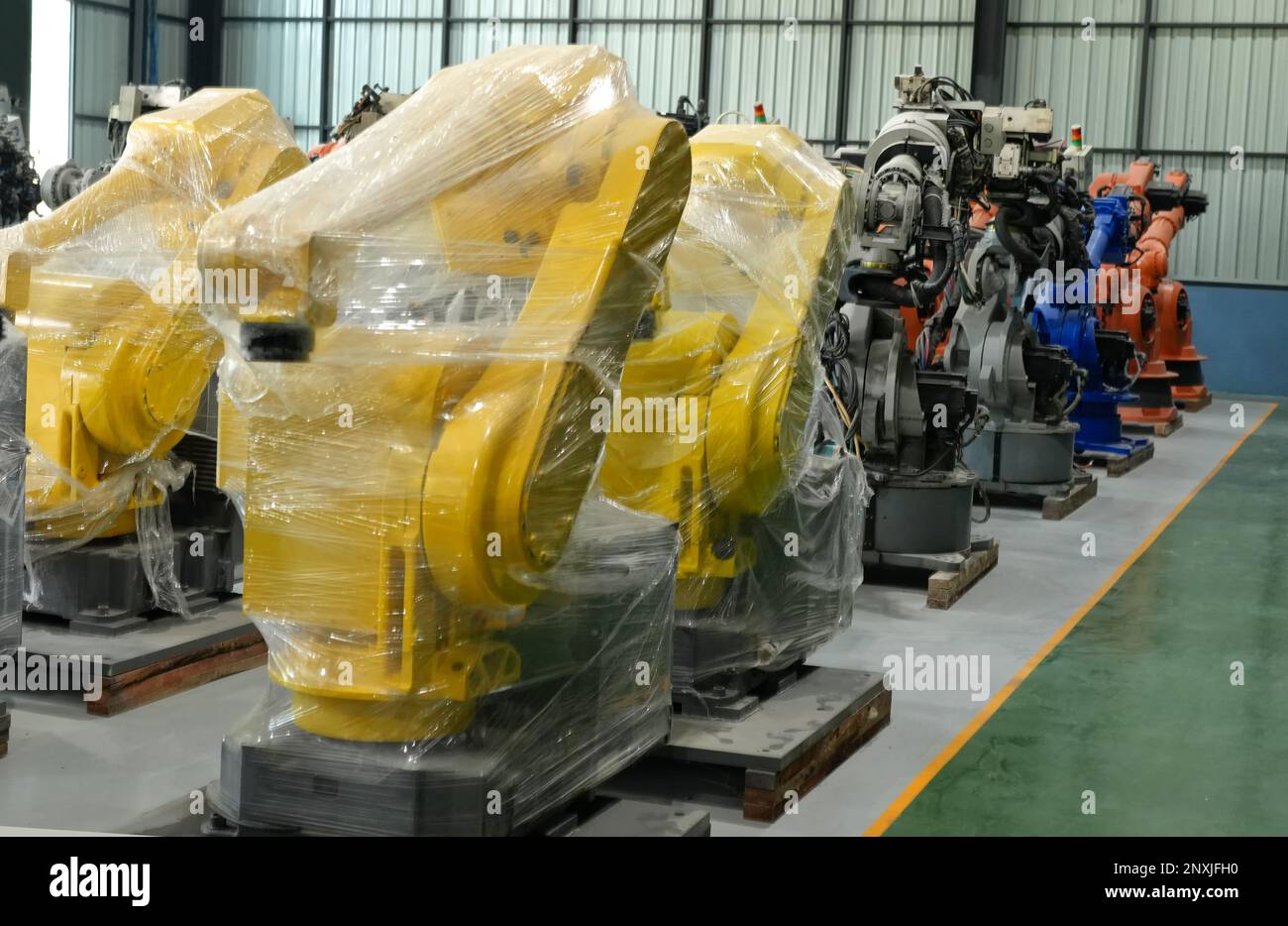 Robotic arm in futuristic assembly manufacturing factory, in factory ...