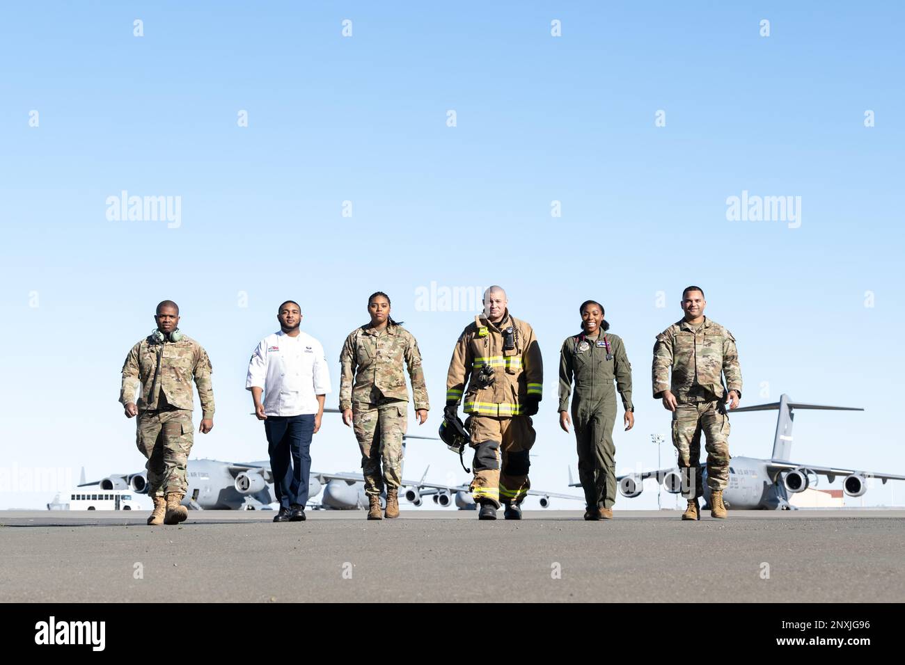 U.S. Airmen walk on the flight line as part of a Black History Month ...