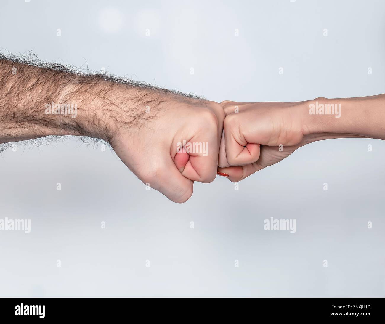 two hands man and woman giving fist bump Stock Photo - Alamy