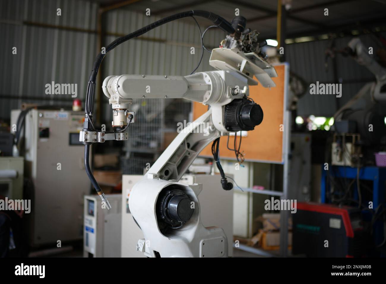 Robotic arm in futuristic assembly manufacturing factory, in factory ...