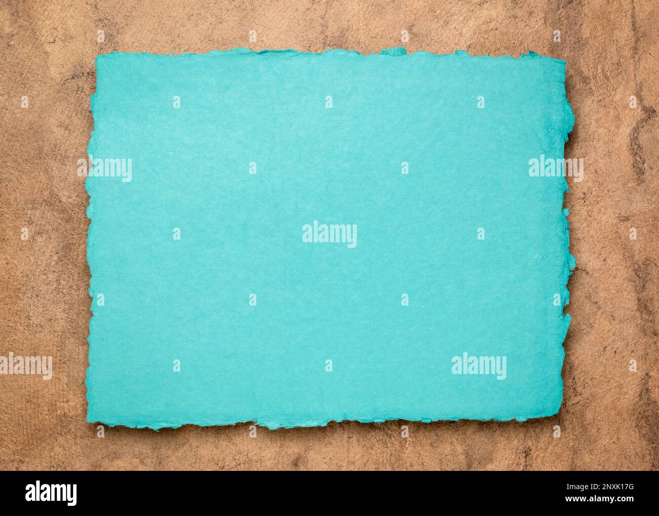 blue and brown abstract, a sheet of blank rag paper against textured ...