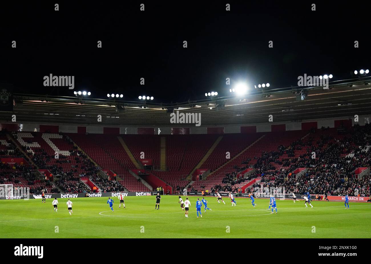 General view of the action on the pitch with empty seats in the stands ...