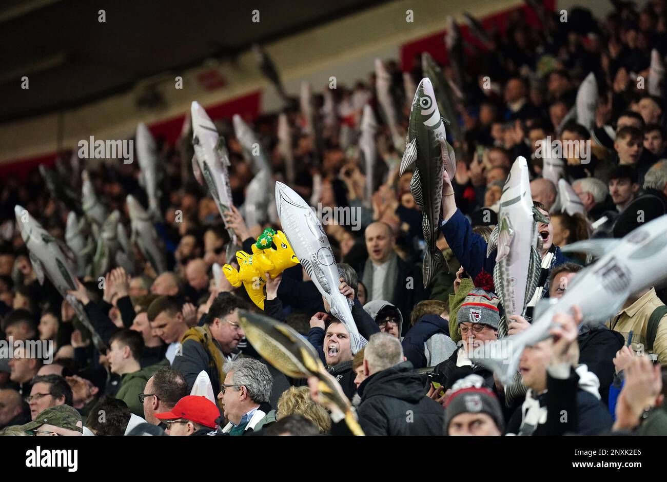 Grimsby Town fans hold up inflatable fish in the stands during the ...