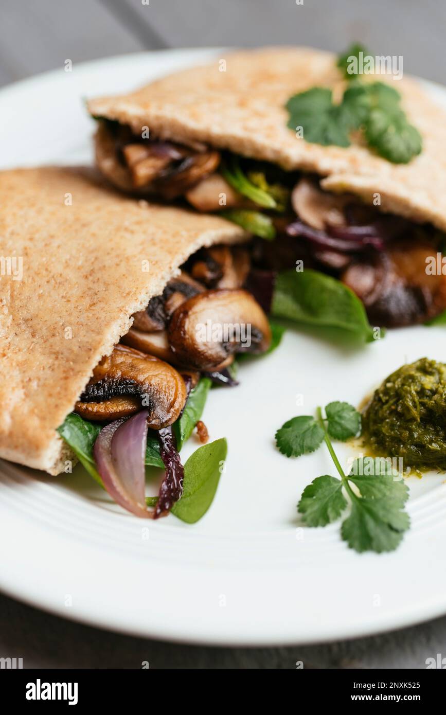 Pita breads filled with sauteed mushrooms and onions with winter ...
