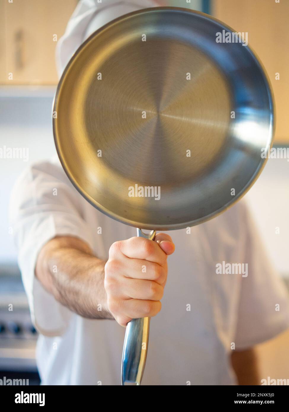 Portrait of a chef hiding his face with a stainless pan Stock Photo - Alamy