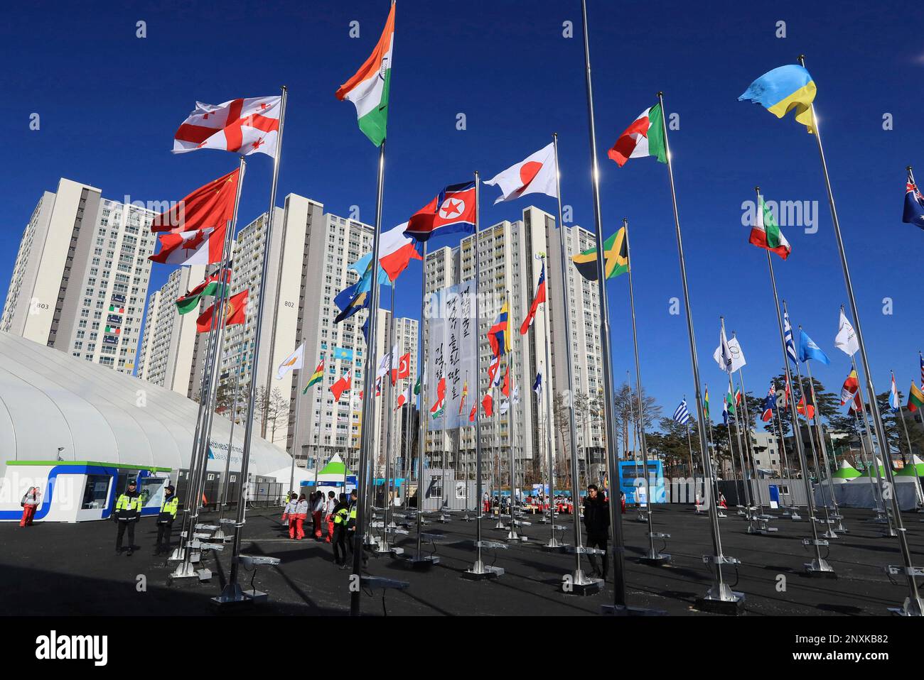 North Korea's flag(C) and other country's national flags are hoisted at ...
