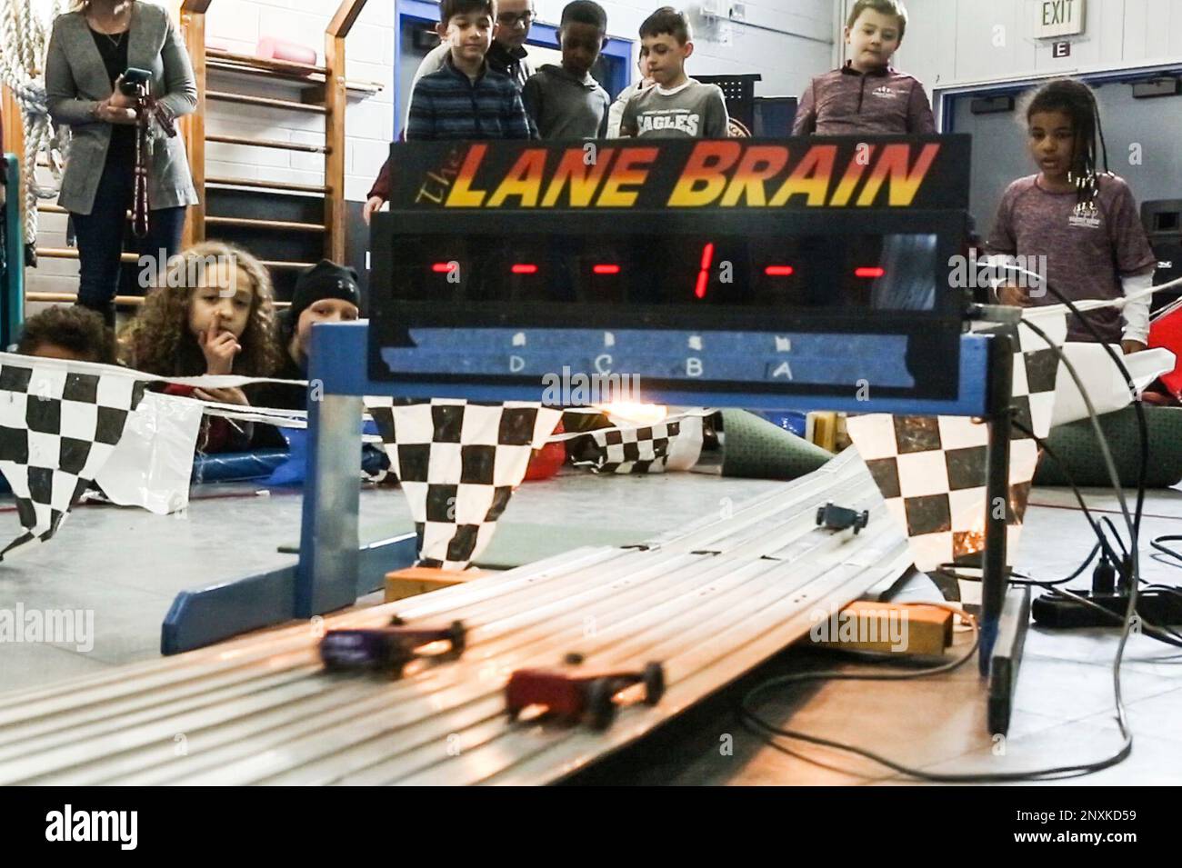 In this undated photo, Pinewood derby racers zoom through the finish ...